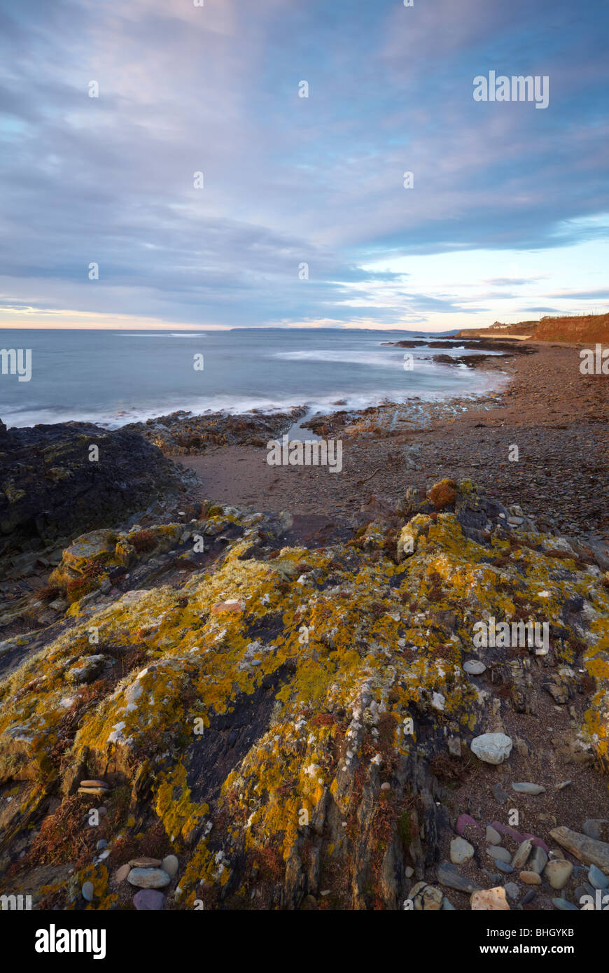 morning sunlight illuminates the shoreline on Guileen Strand, Co.Cork ...
