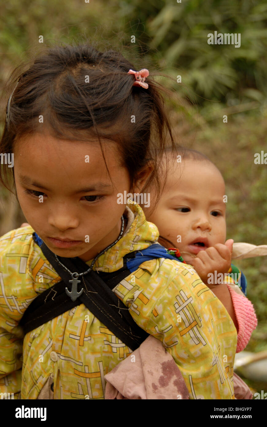 minority flower hmong girl carrying her brother, lao cai, can cau ...