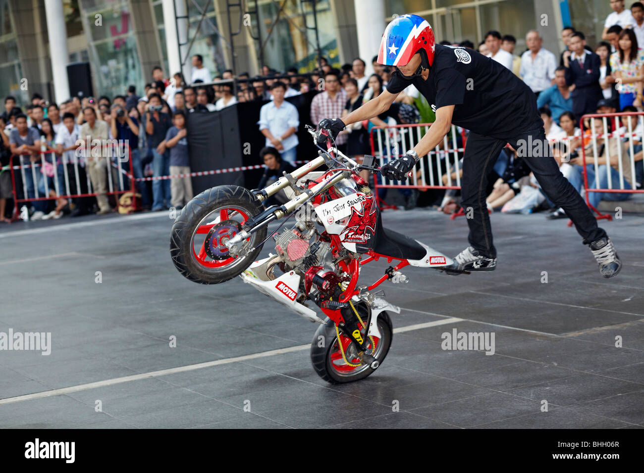 Stunt man riding motorbike at the annual Bangkok motorcycle show ...