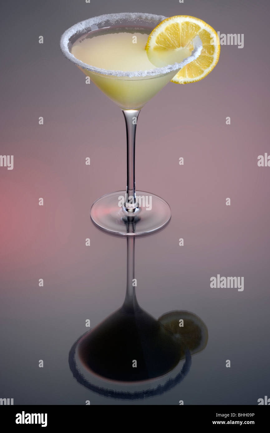 Lemon Drop cocktail with orange garnish on gray background Stock Photo ...