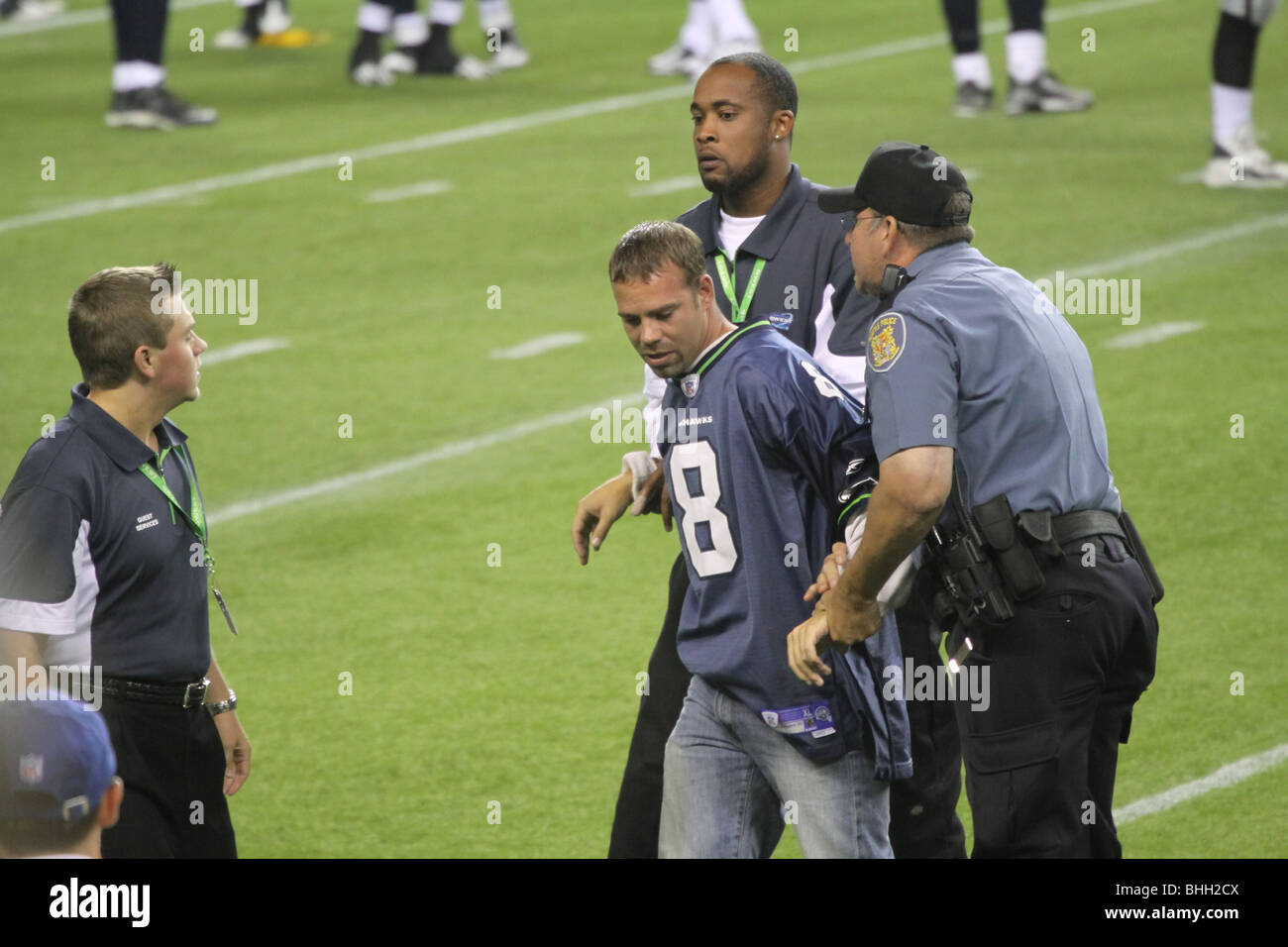 Drunk football fan arrested for running out on the field during a live ...