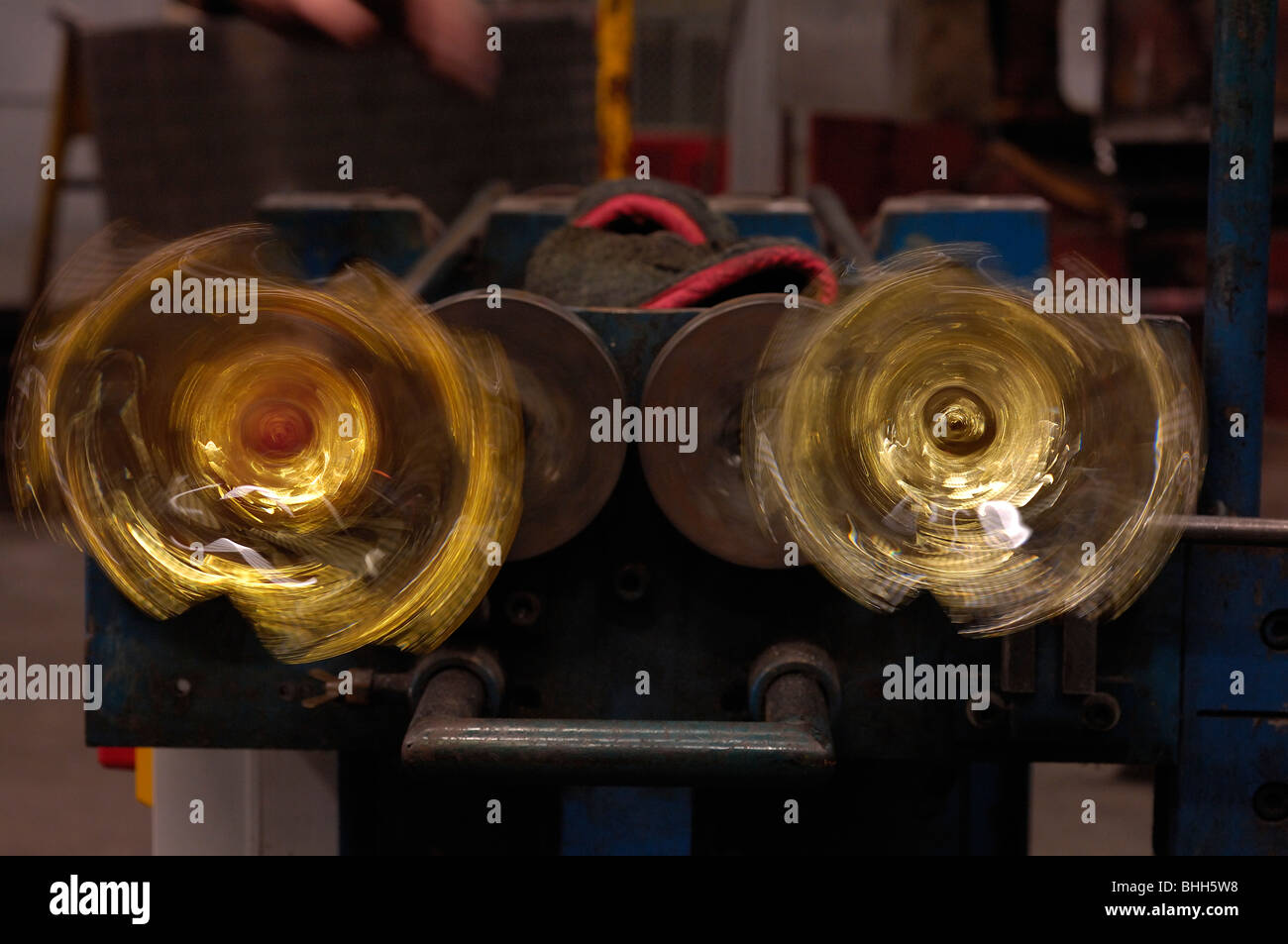 hot glass rotating on a turning machine during manufacture Stock Photo ...
