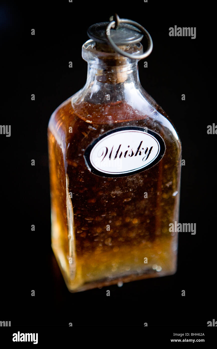 An old bottle of whiskey Stock Photo - Alamy