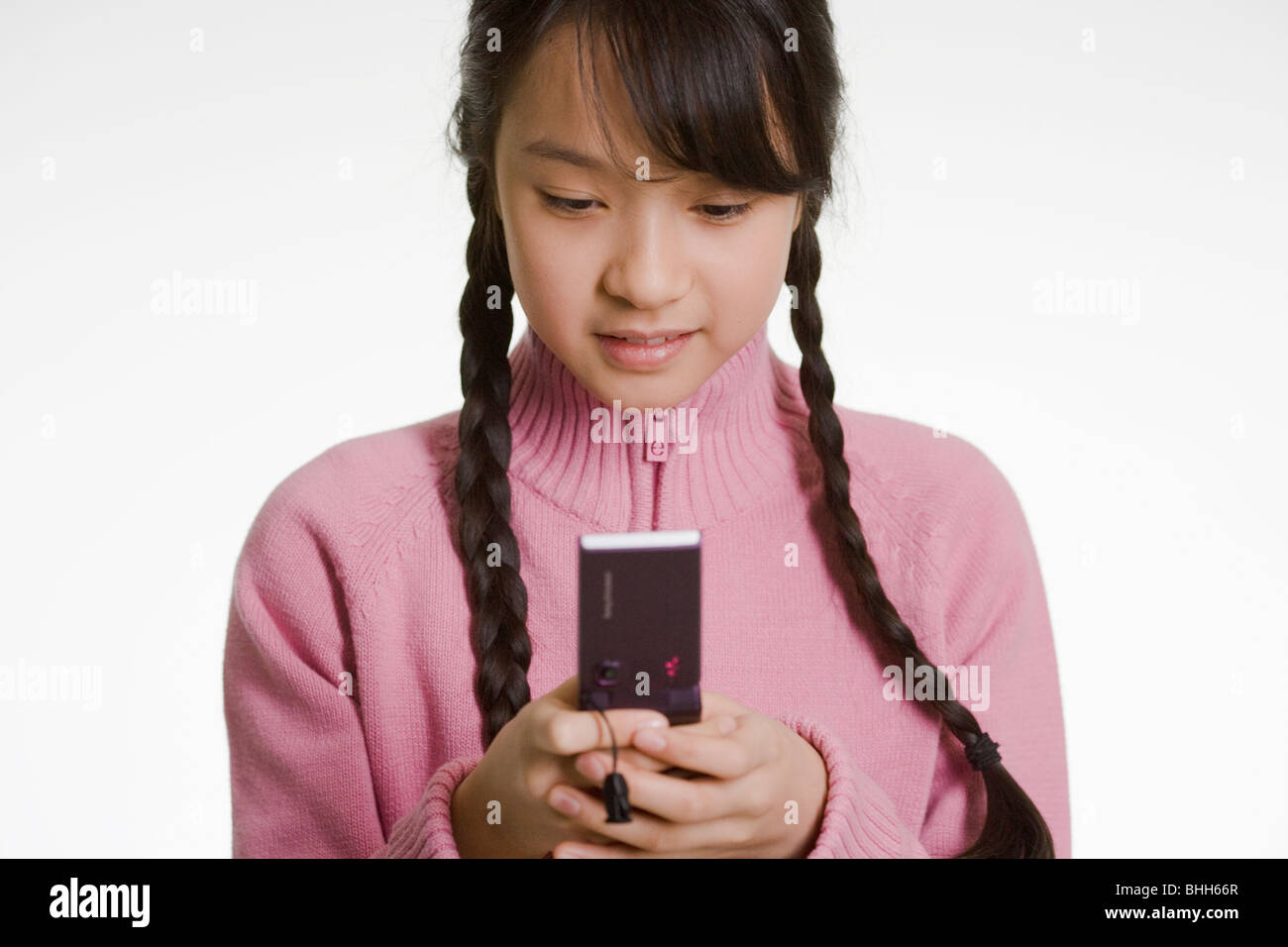 Happy girl using a mobile phone Stock Photo - Alamy
