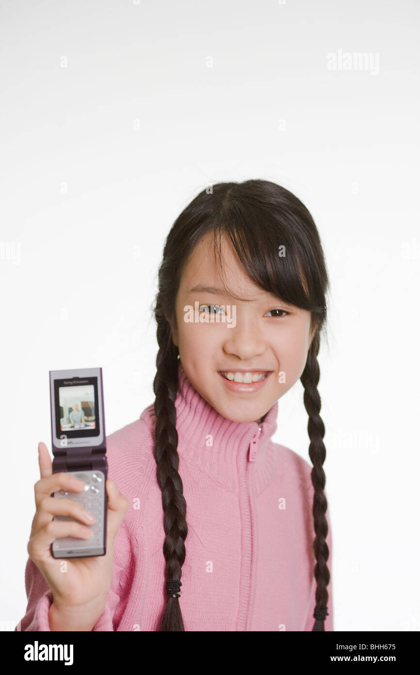 Happy girl using a mobile phone Stock Photo - Alamy