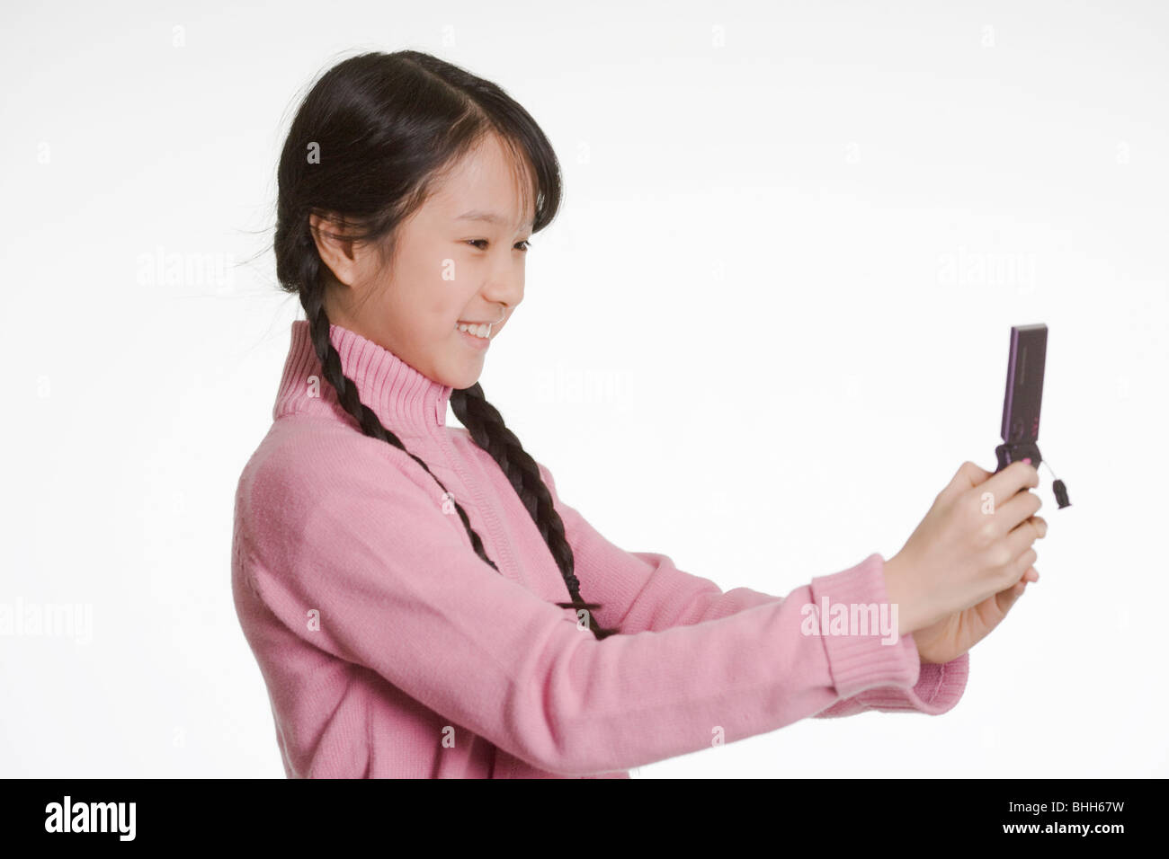 Happy girl using a mobile phone Stock Photo - Alamy
