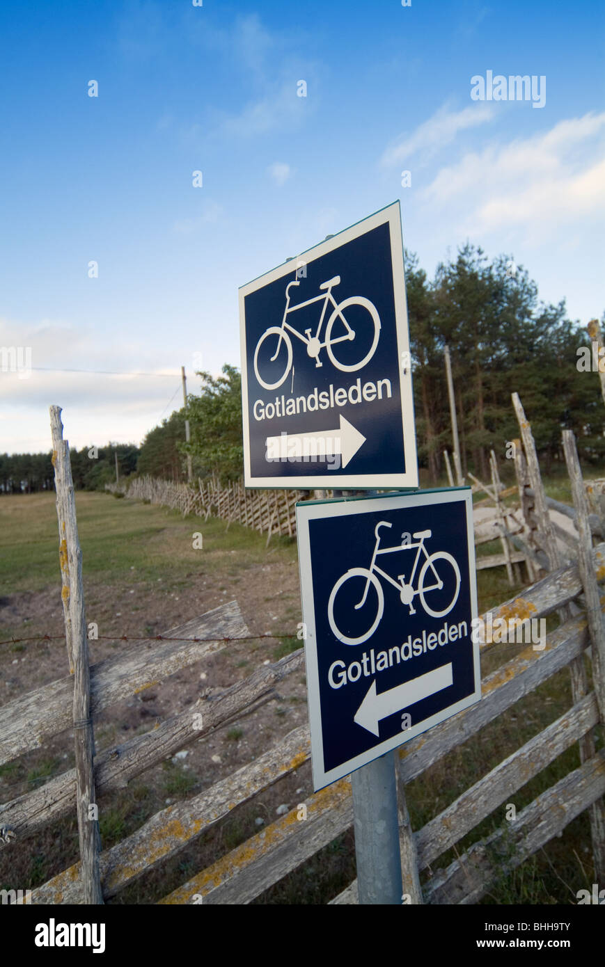 Cycleway signs by a fence, Gotland, Sweden Stock Photo - Alamy