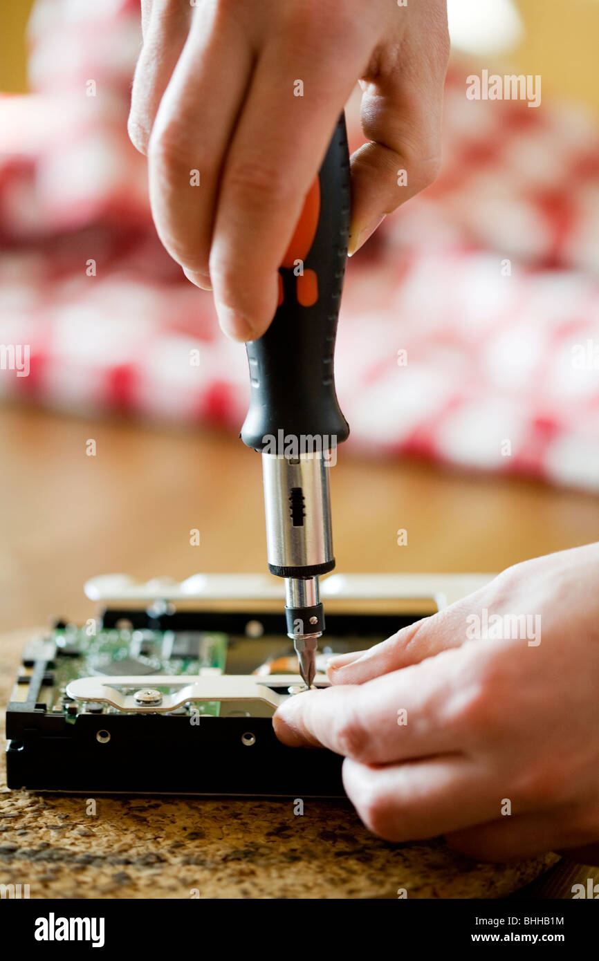 Hands screwing on a hard disk hi-res stock photography and images - Alamy