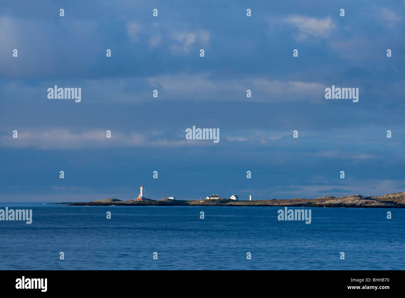 A lighthouse and houses on a point of land, Norway Stock Photo - Alamy