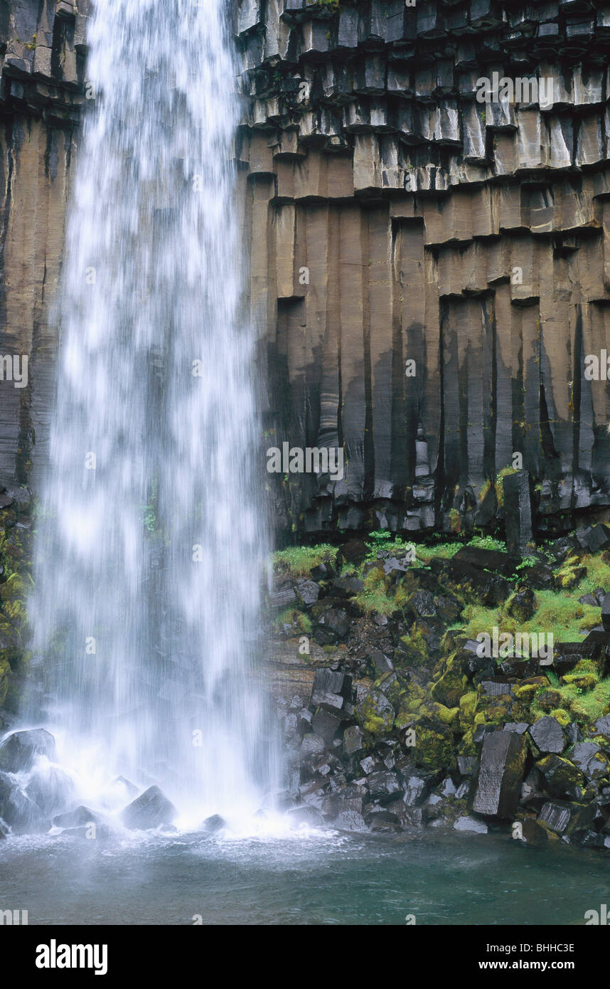 A waterfall surrounded by basalt columns, Iceland Stock Photo - Alamy