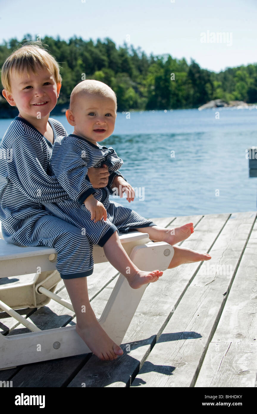 Brother and sister on a jetty, Stockholm archipelago, Sweden Stock ...