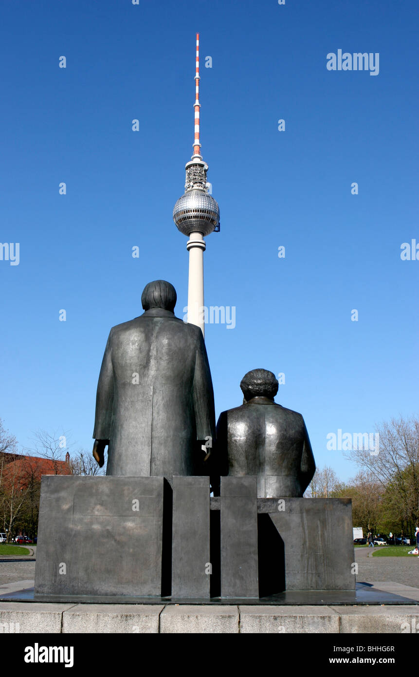 Statue of Karl Marx and Engels looking up at the TV Tower in Berlin ...
