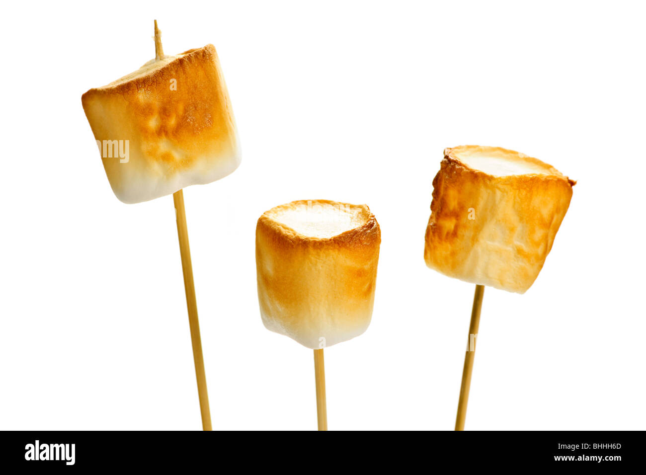 Three golden toasted marshmallows on wooden skewers Stock Photo - Alamy