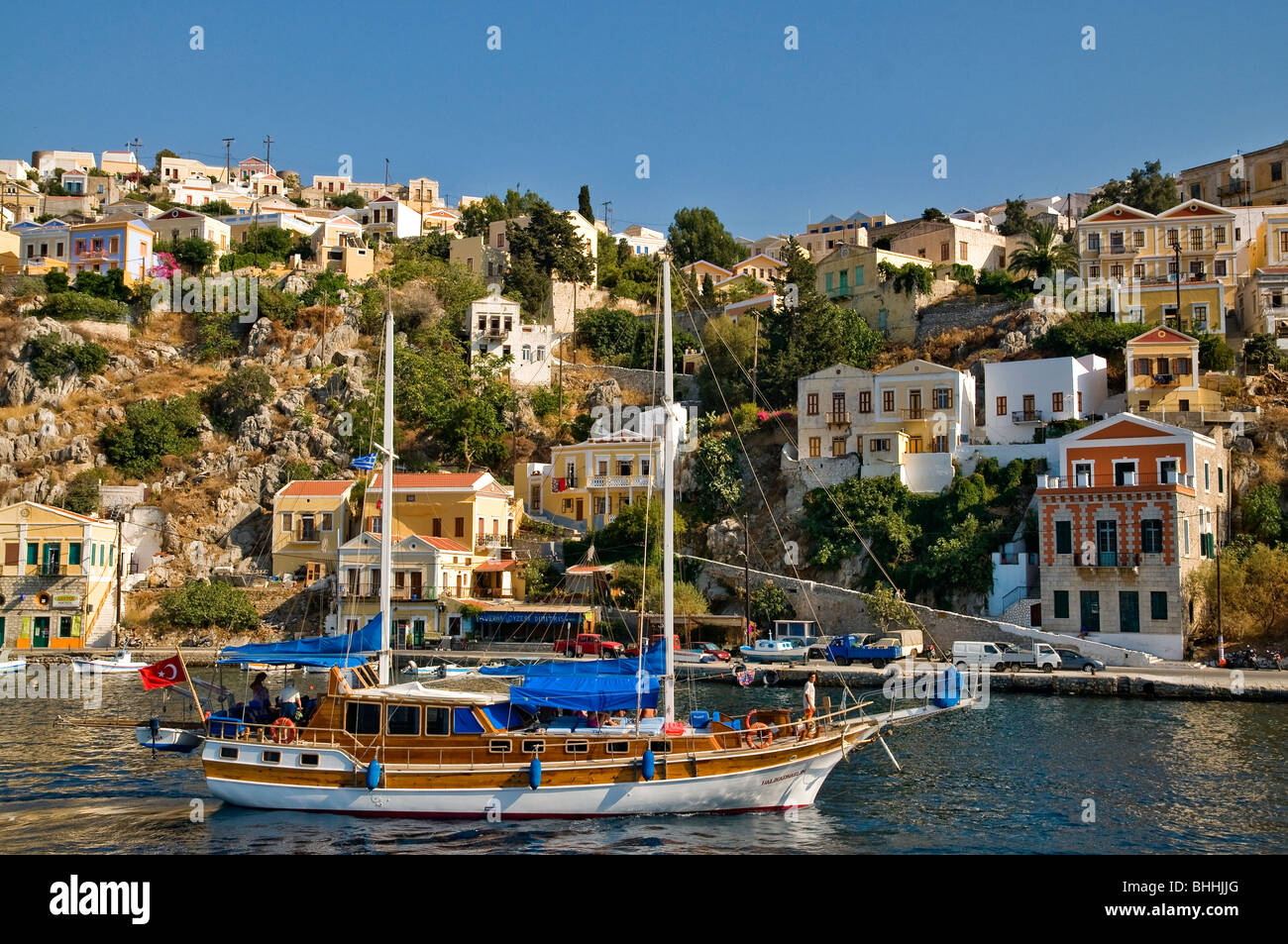 Symi Island, Wooden Tourist boat and houses, Greece Stock Photo - Alamy