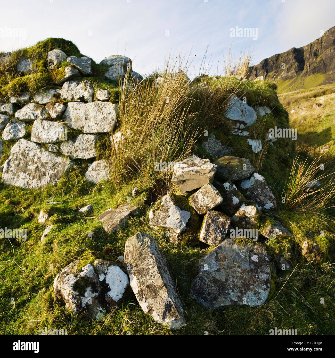 Crumbling stone wall of old croft building, Trotternish, Isle of Skye ...