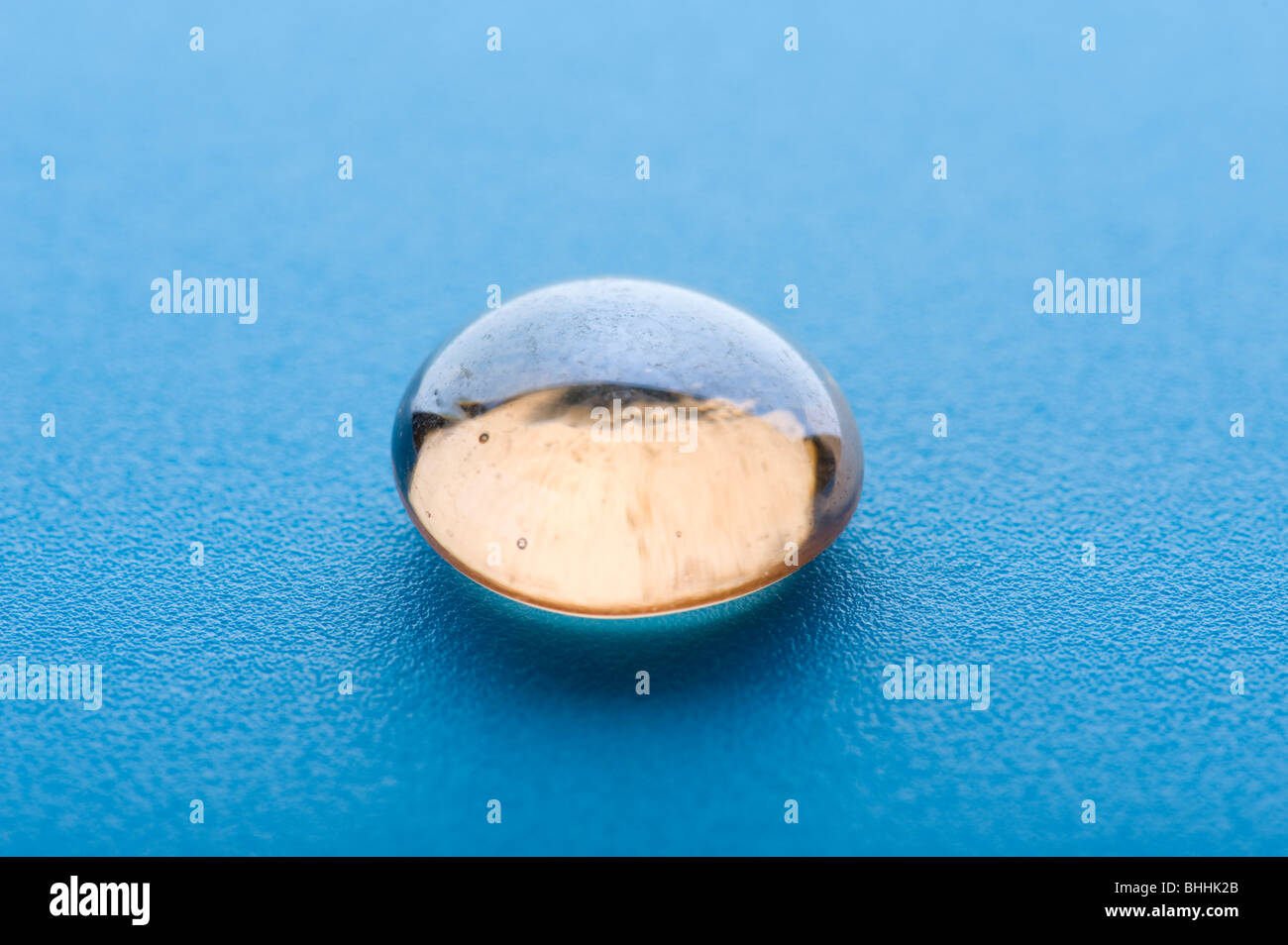 object on blue - Glass drop close up Stock Photo - Alamy