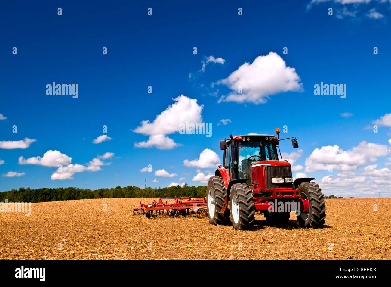 Small scale farming with tractor and plow in field Stock Photo - Alamy