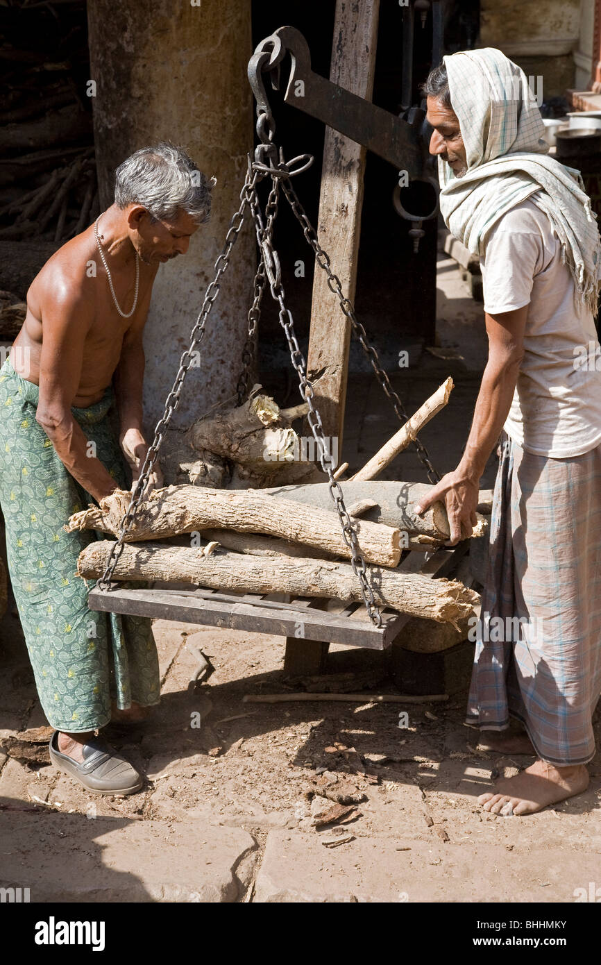 Men weighing wood for the ritual corpse cremation. Manikarnika Ghat ...