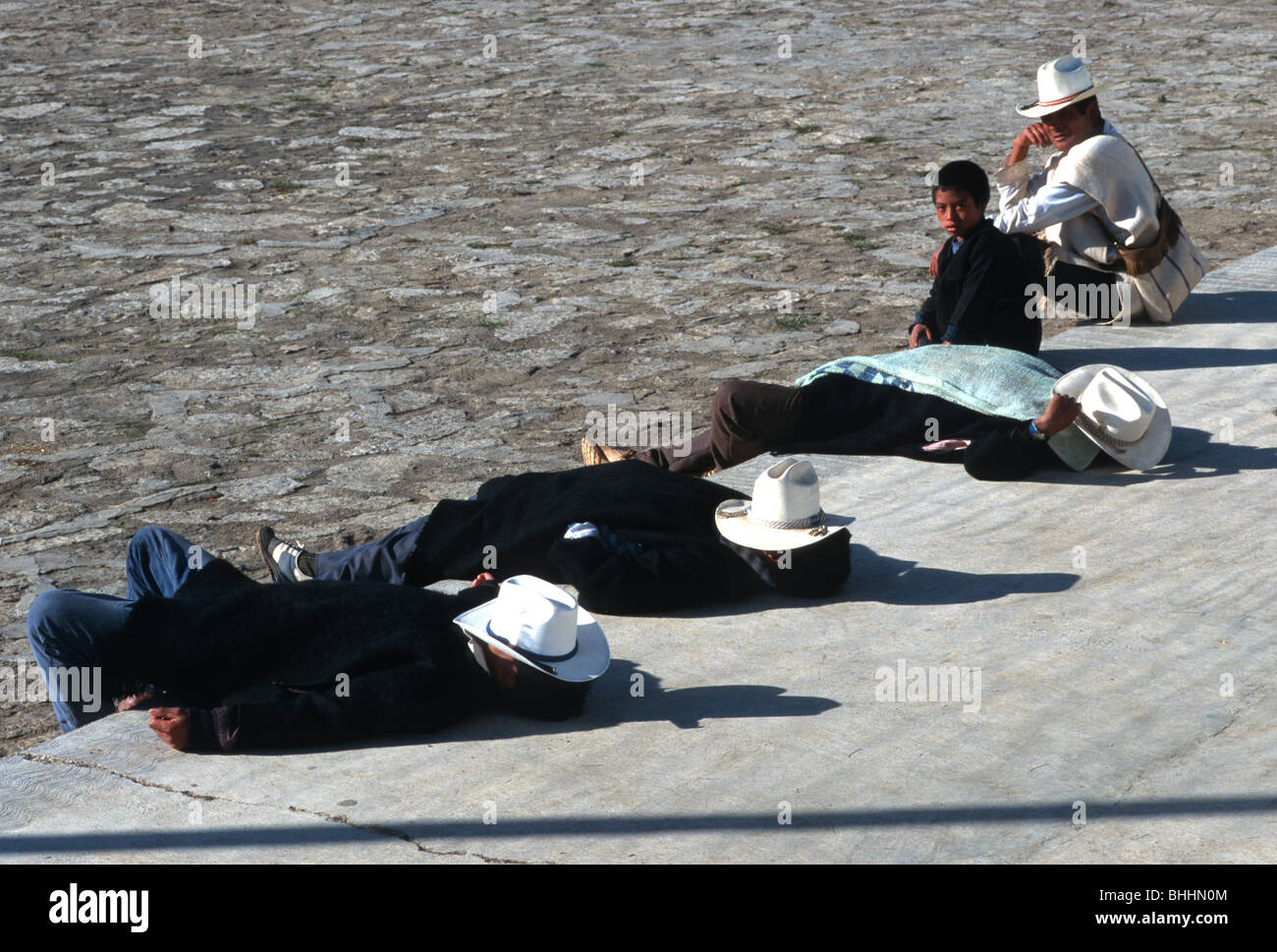 Mexican men wearing sombreros, resting in the village square, San Juan ...