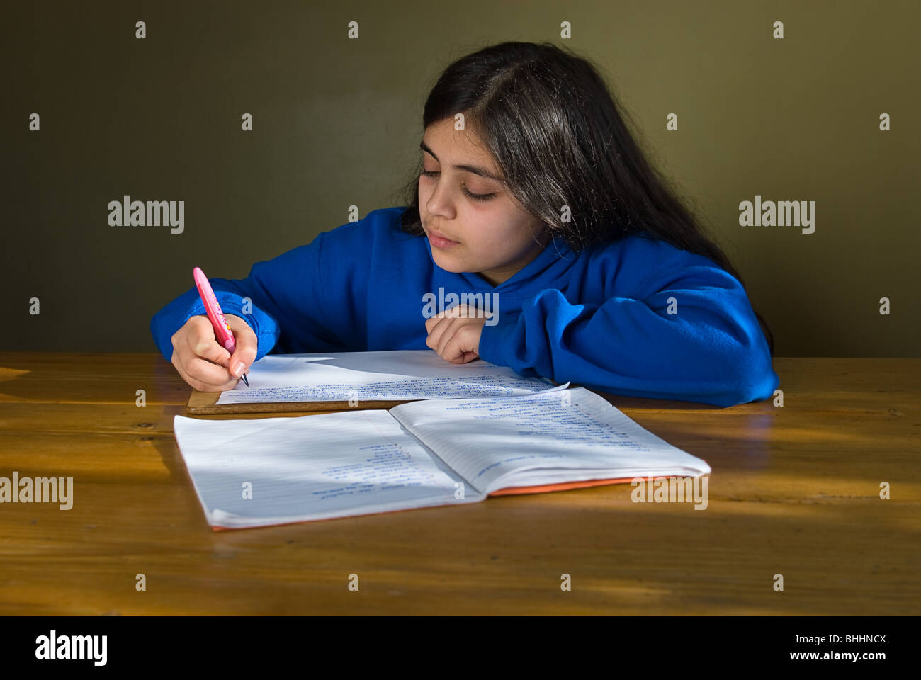 Young happy child studying and doing homework after school at home on ...