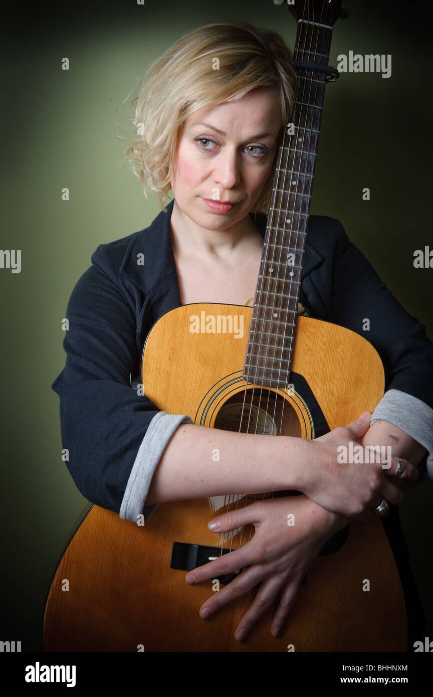 Attractive blonde female with guitar Stock Photo - Alamy