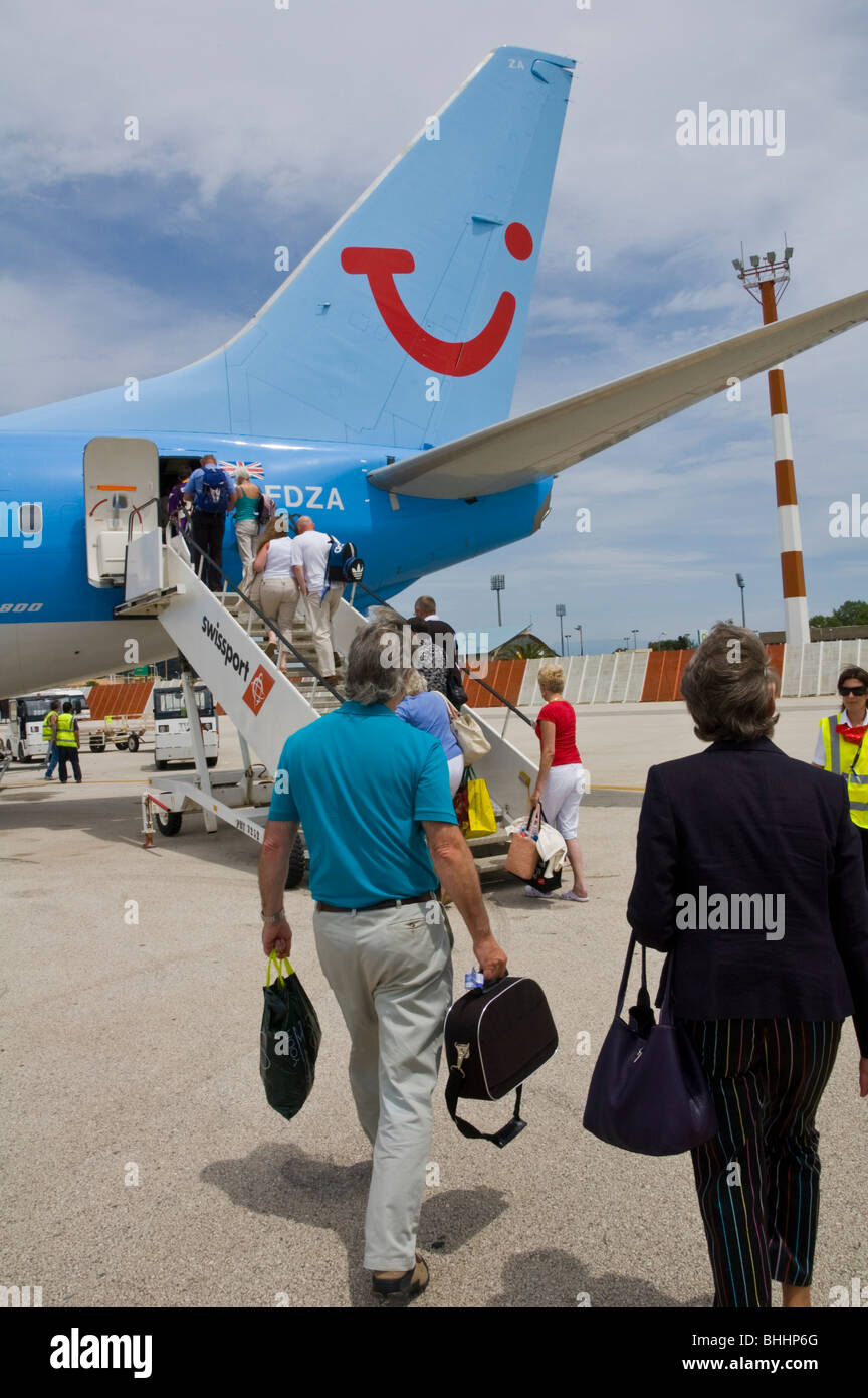 Passengers boarding aircraft at airport on the Greek Mediterranean ...