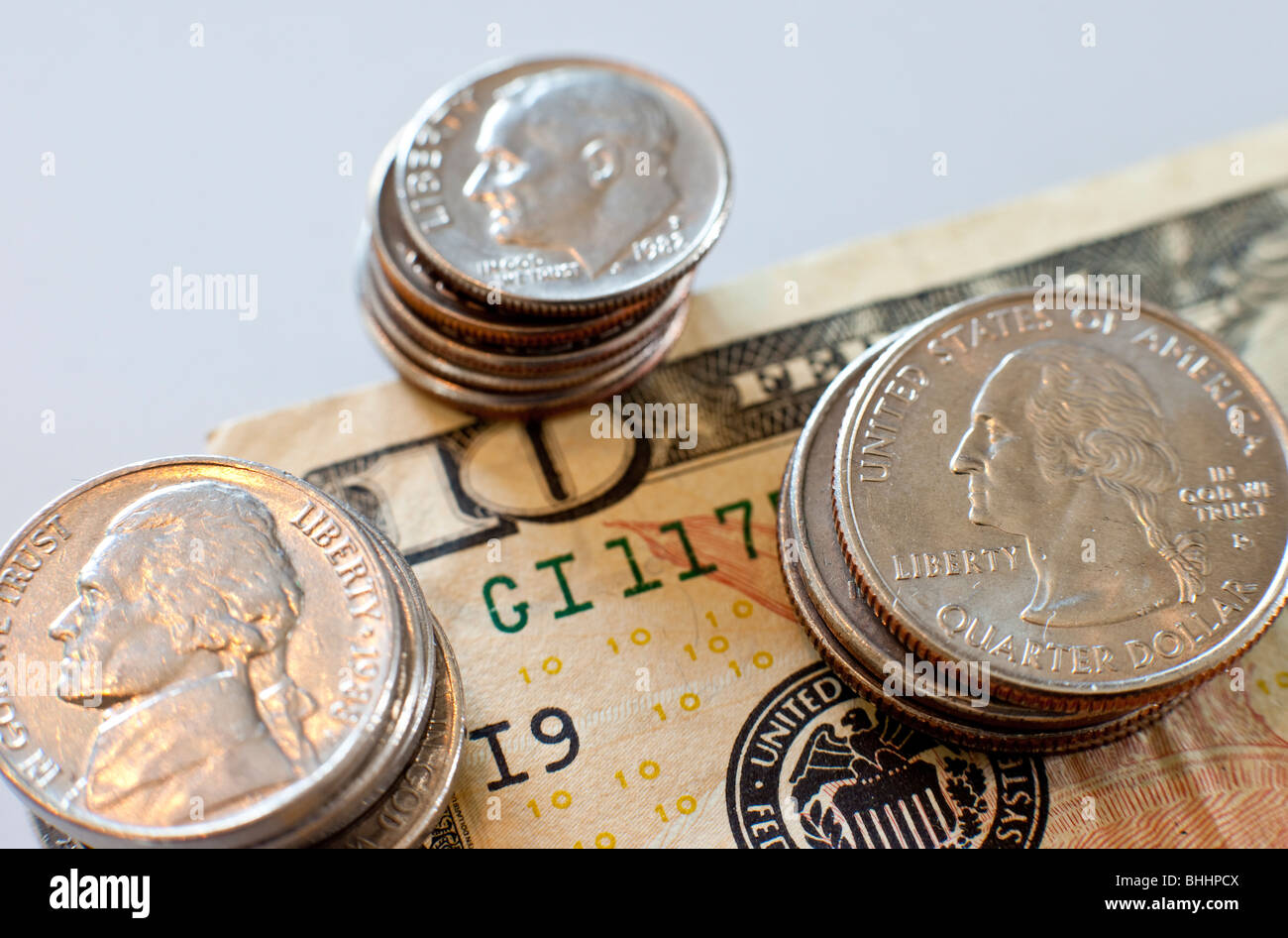 US coins and ten dollar bill on white background Stock Photo - Alamy