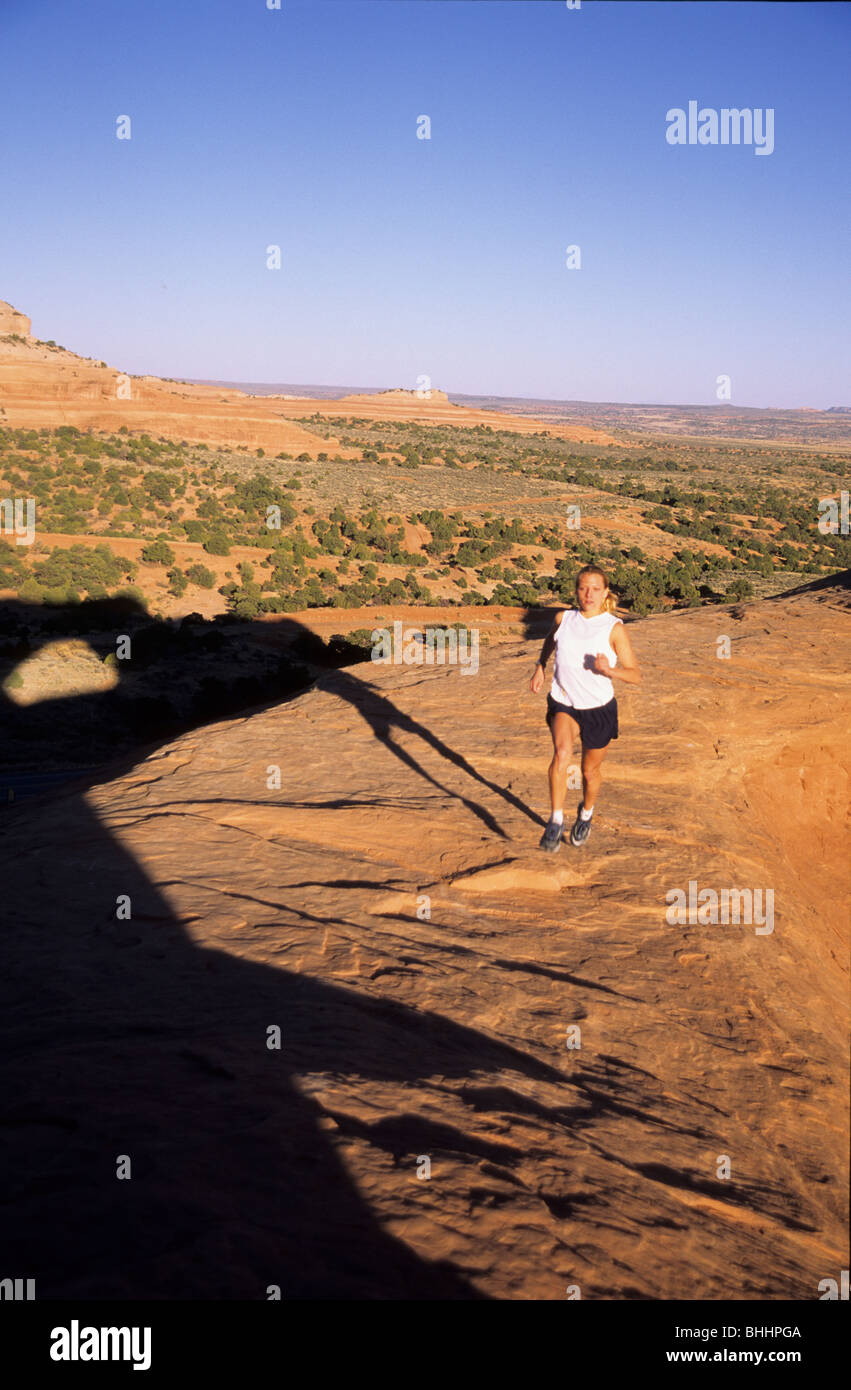 Woman running in desert Stock Photo - Alamy