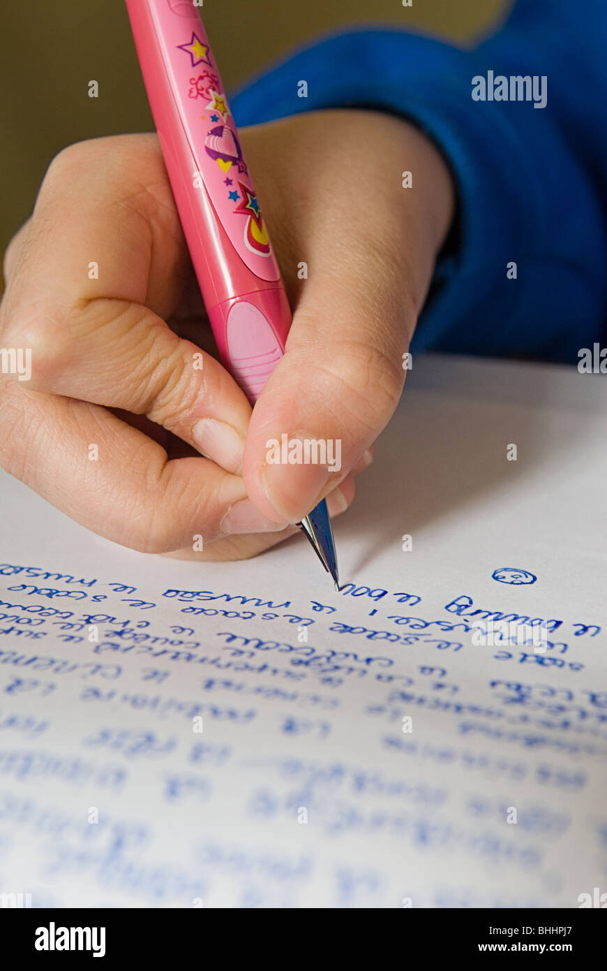 Young happy child studying and doing homework after school at home on ...