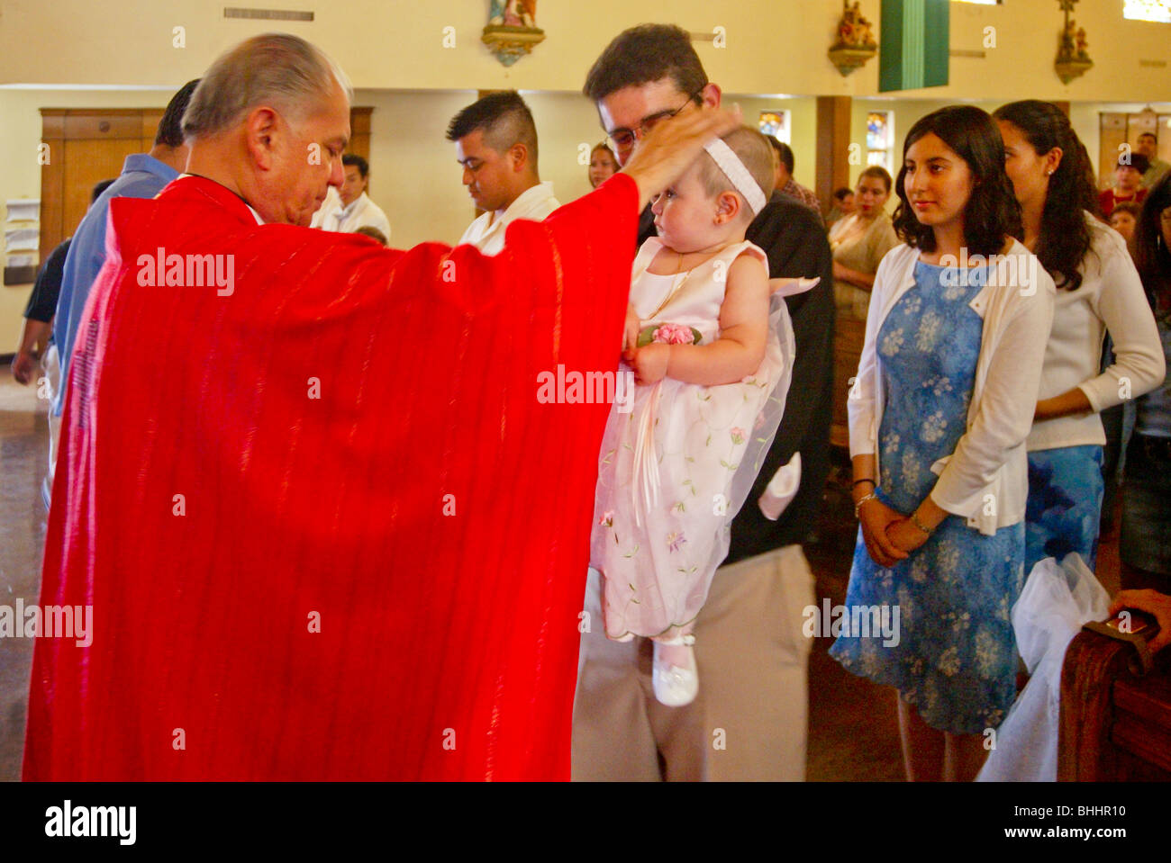 A priest offers communion at Mass to his mostly Hispanic parishioners ...