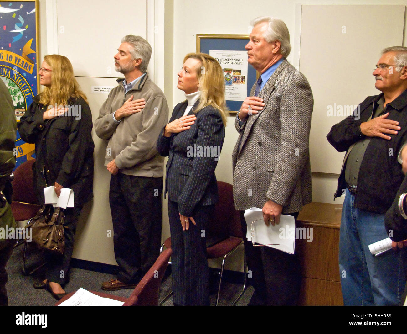Hands over their hearts, local citizens recite the Pledge of Allegiance ...