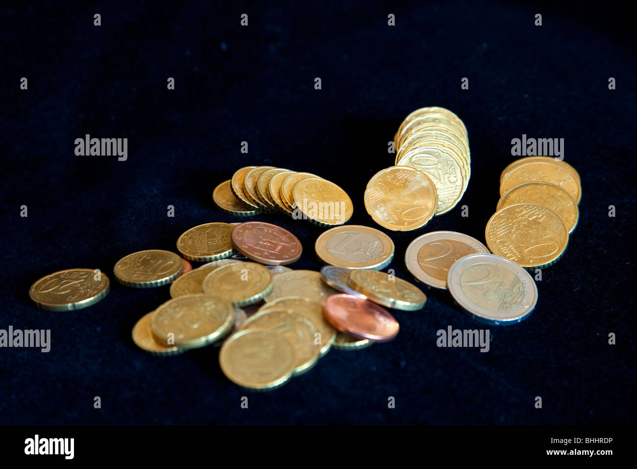 Euro coins on black background Stock Photo - Alamy