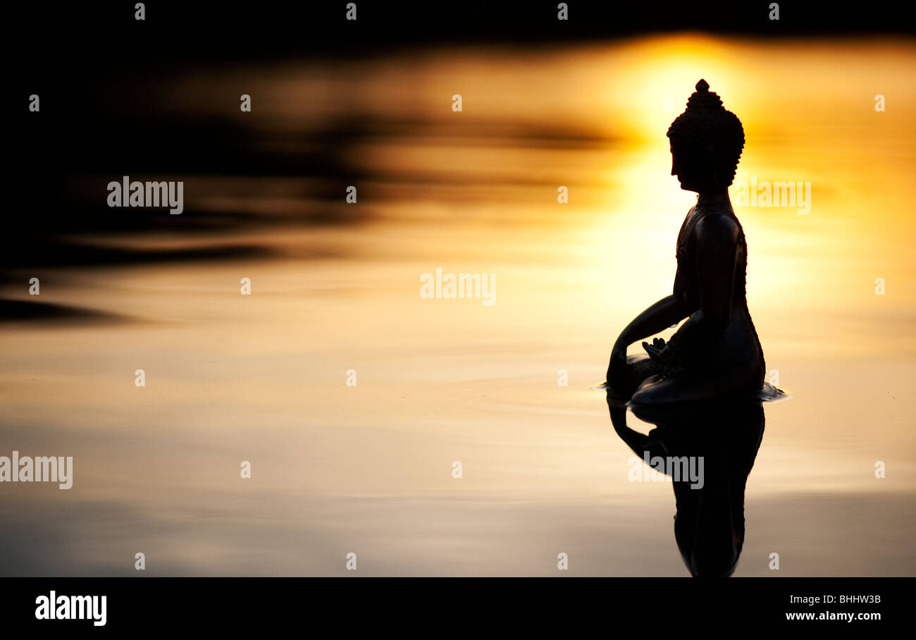 Silhouette of Buddha statue floating on calm still water surface at ...