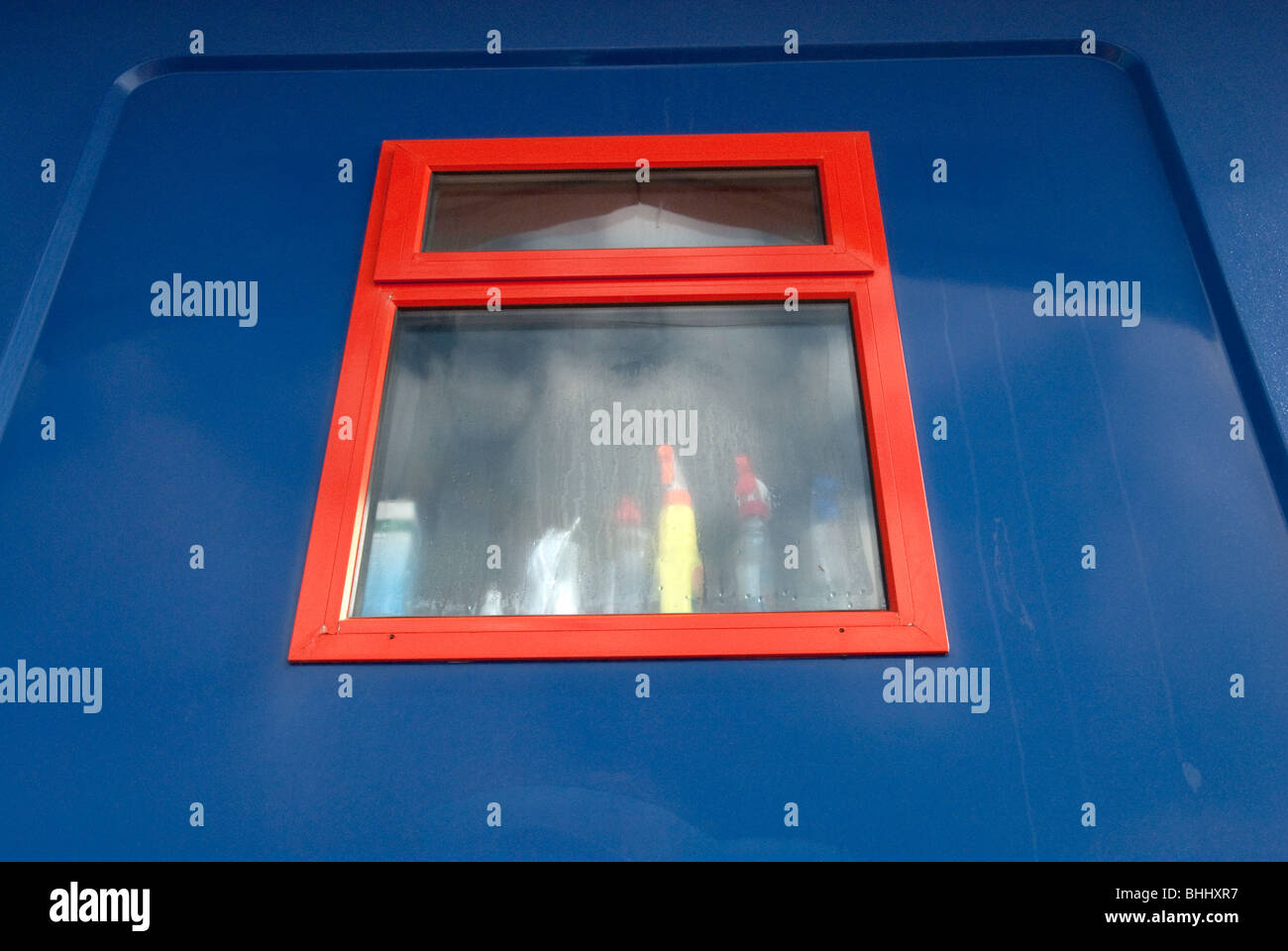Red window in blue wall Stock Photo - Alamy