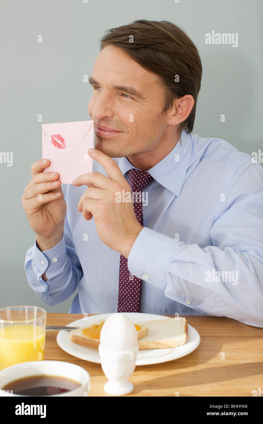 man taking a smell at a love letter Stock Photo - Alamy