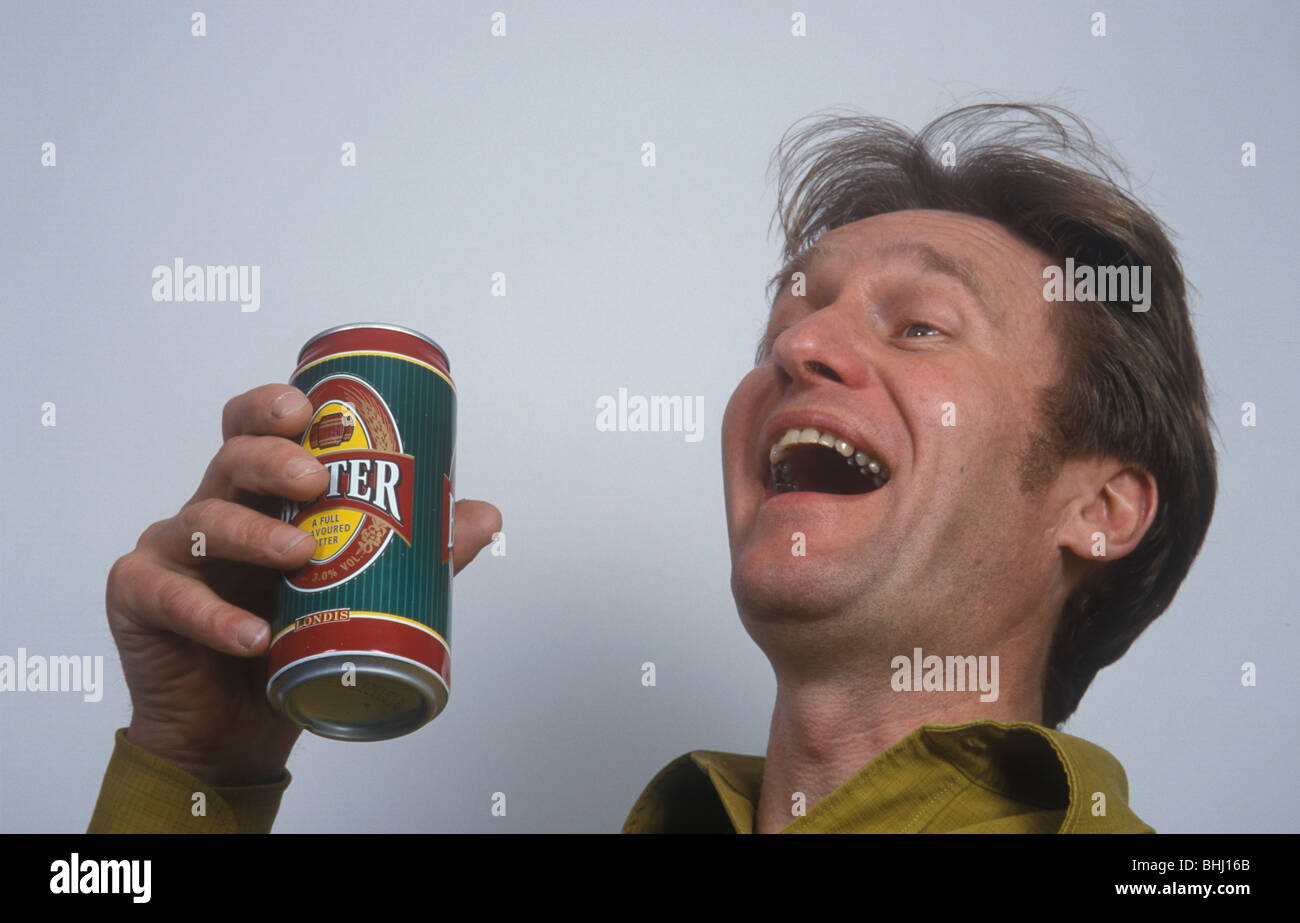 man looking drunk holding a can of beer Stock Photo - Alamy