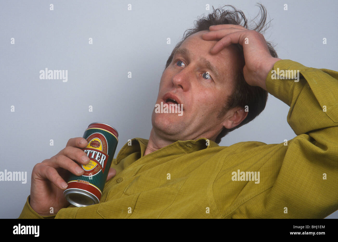 man looking drunk holding a can of beer Stock Photo - Alamy
