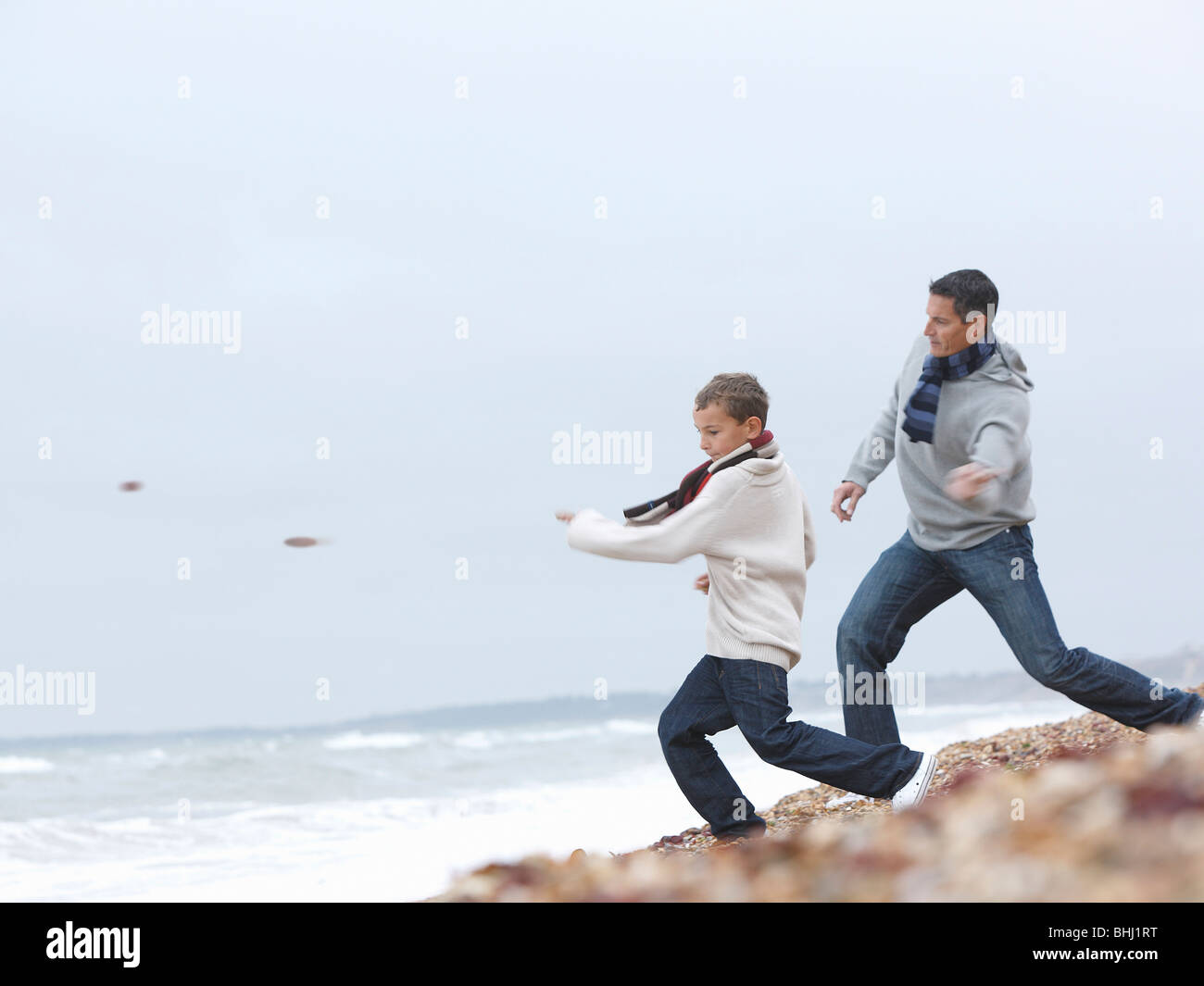 Father and Son Stone-Skipping Stock Photo - Alamy