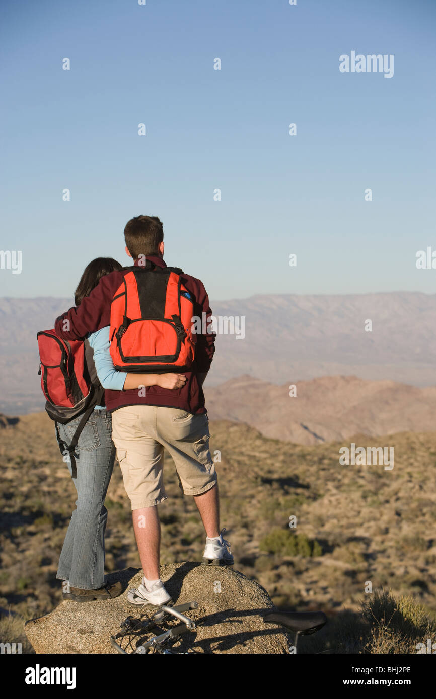 Young couple stand looking at view Stock Photo - Alamy