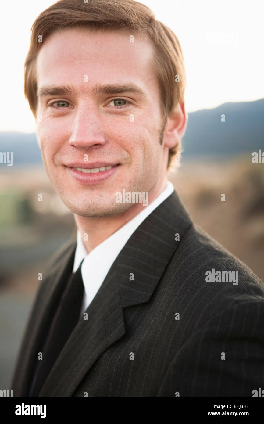 Man in suit smiling outside Stock Photo - Alamy