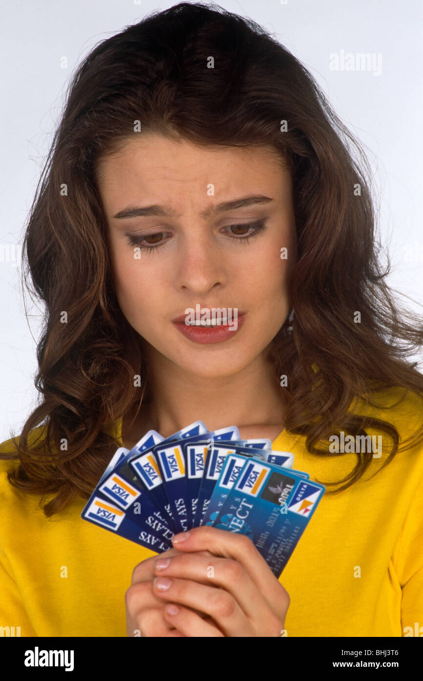 Girl looking at credit cards Stock Photo - Alamy