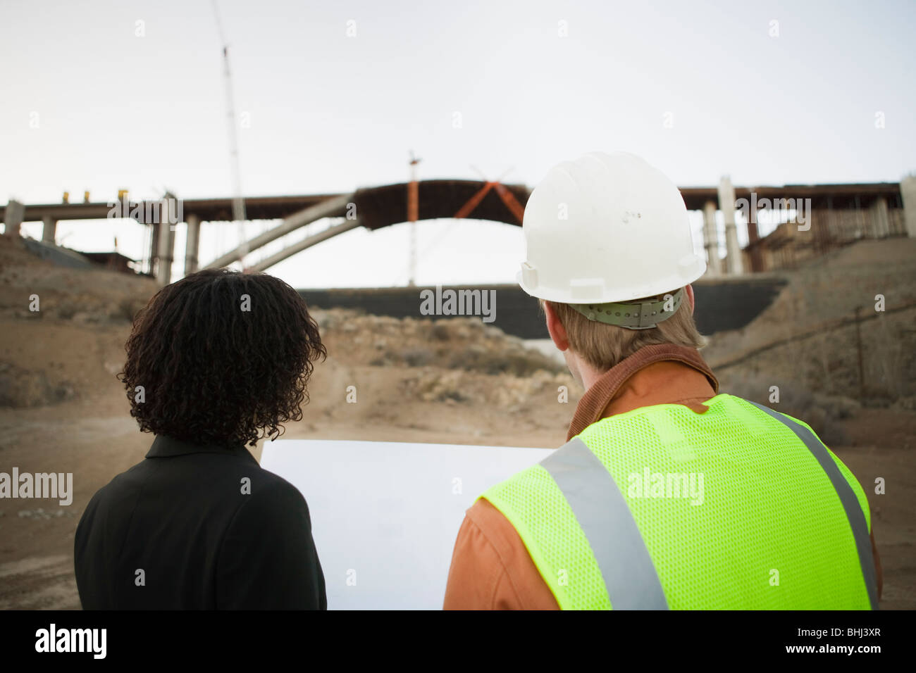 Engineer looking at bridge and plans hi-res stock photography and ...