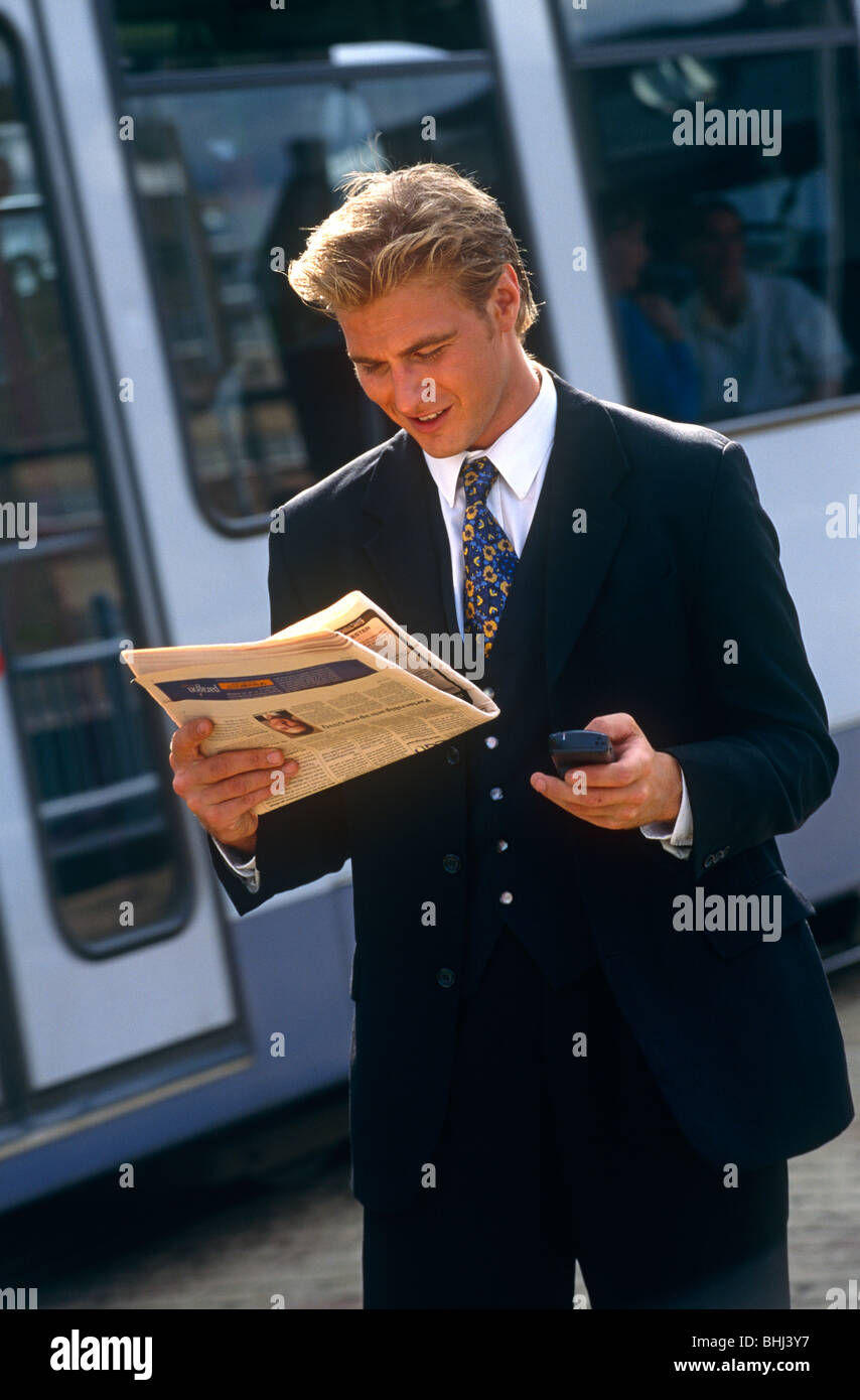 Business man reading paper Stock Photo - Alamy