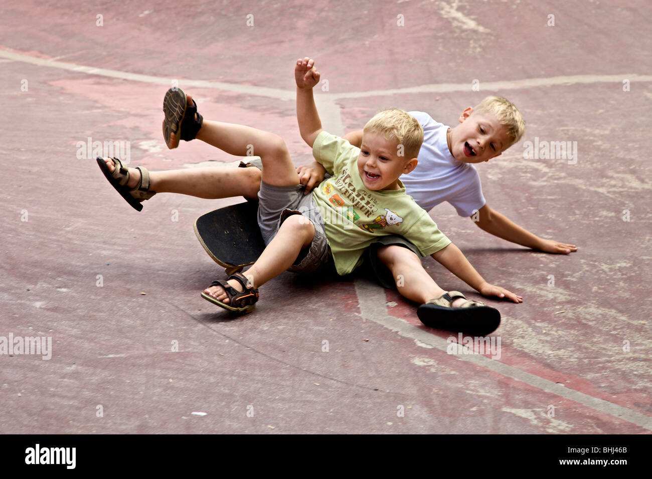 two children playing on the ground Stock Photo - Alamy