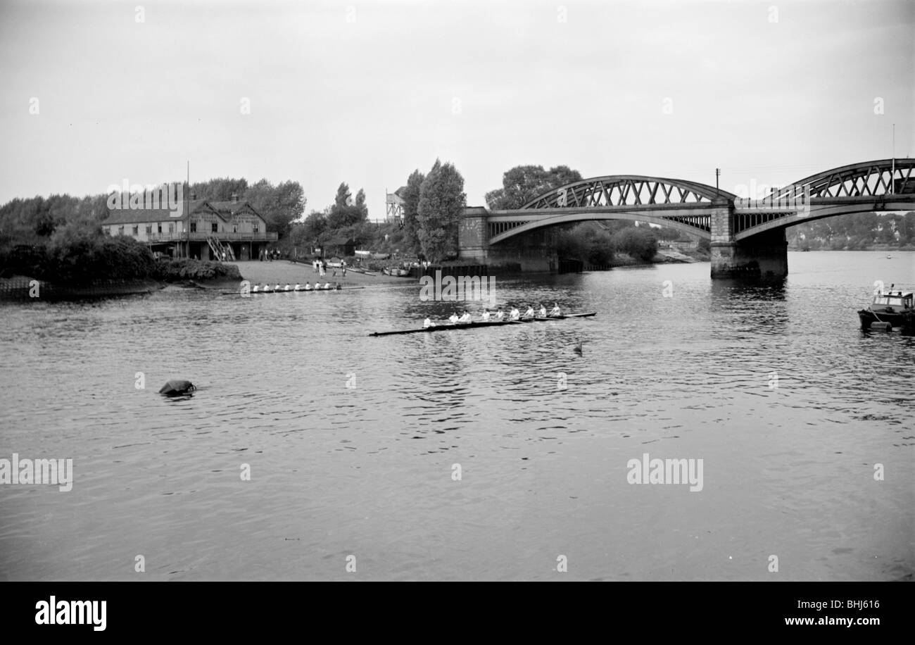 A rowing eight approaches Barnes Bridge, Chiswick, London, c1945-c1965 ...