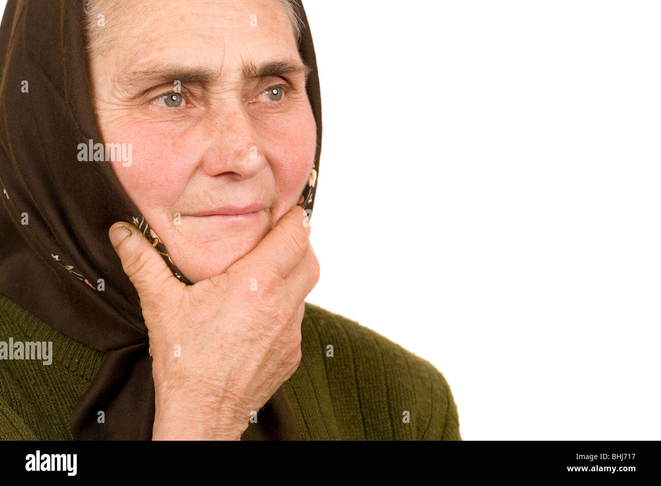 Close-up portrait of an old peasant woman isolated on white background ...
