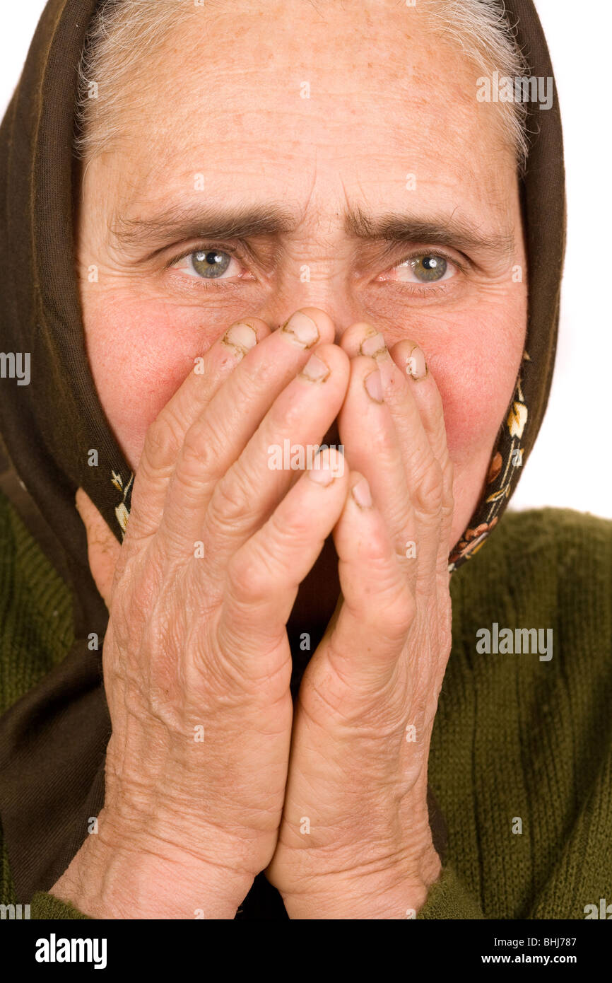 Close-up portrait of an old peasant woman isolated on white background ...