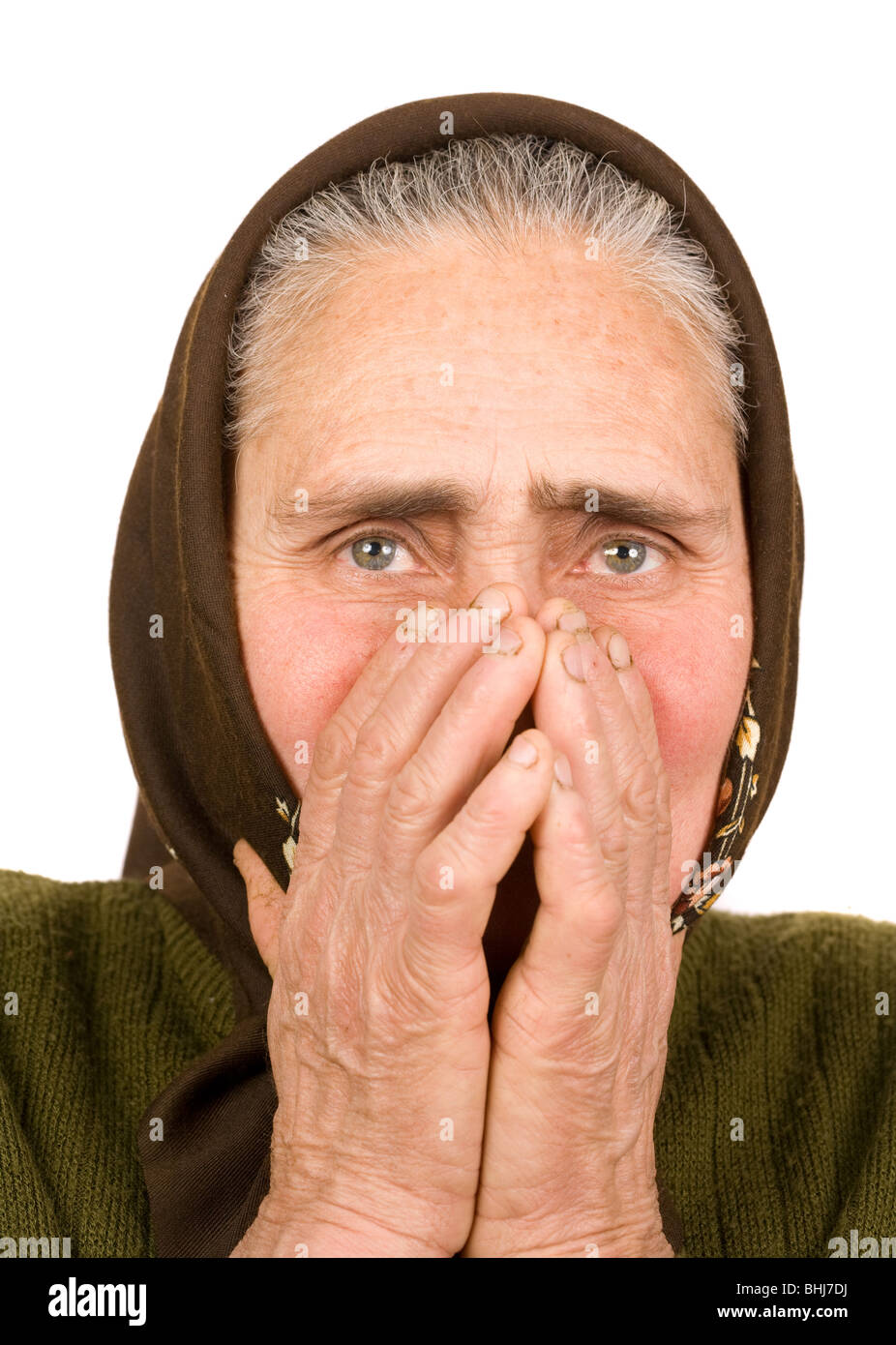 Close-up portrait of an old peasant woman isolated on white background ...
