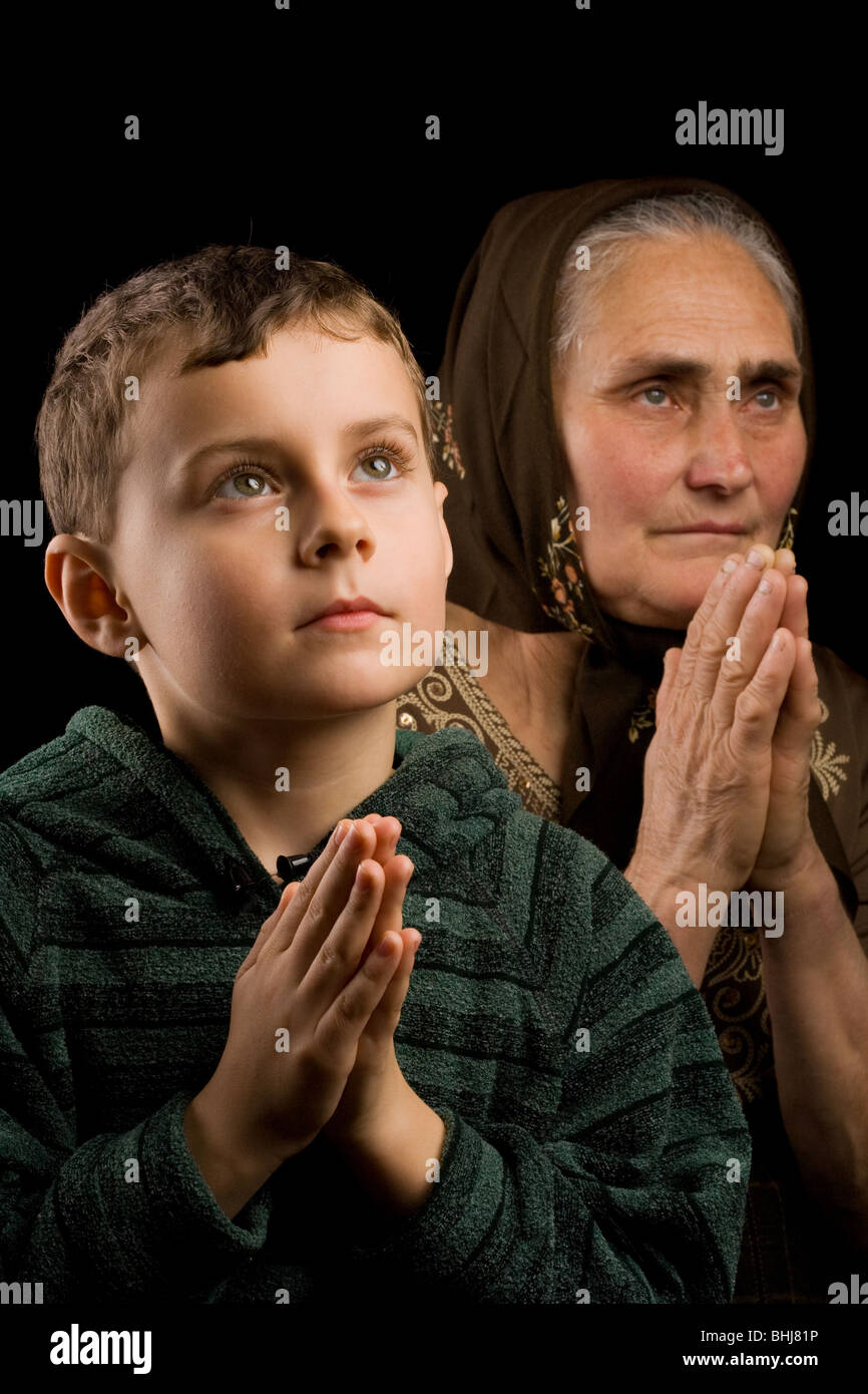 Grandmother and grandson praying together Stock Photo - Alamy