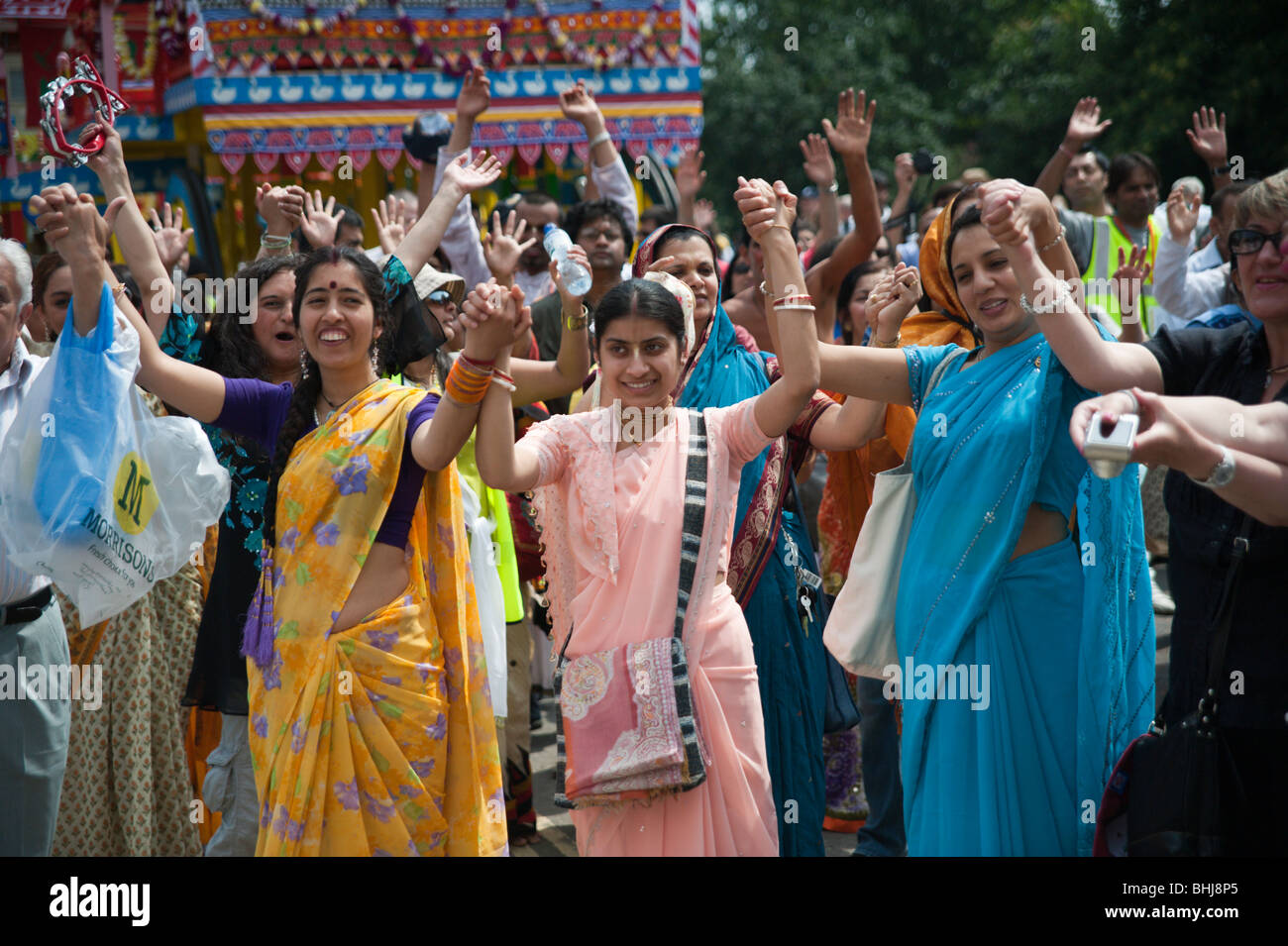 Rathayatra chariot festival, London. Women dance holding hands up in ...